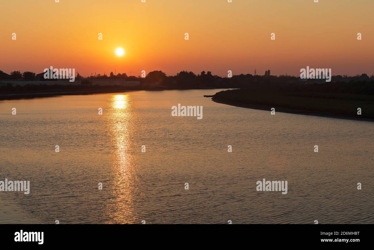 The Kura river flowing through the city of Neftechala at sunset Stock ...