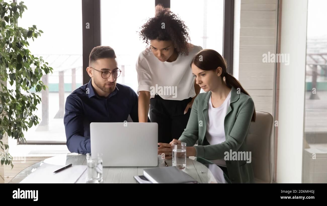 Mixed race business people busy with problem solution Stock Photo - Alamy