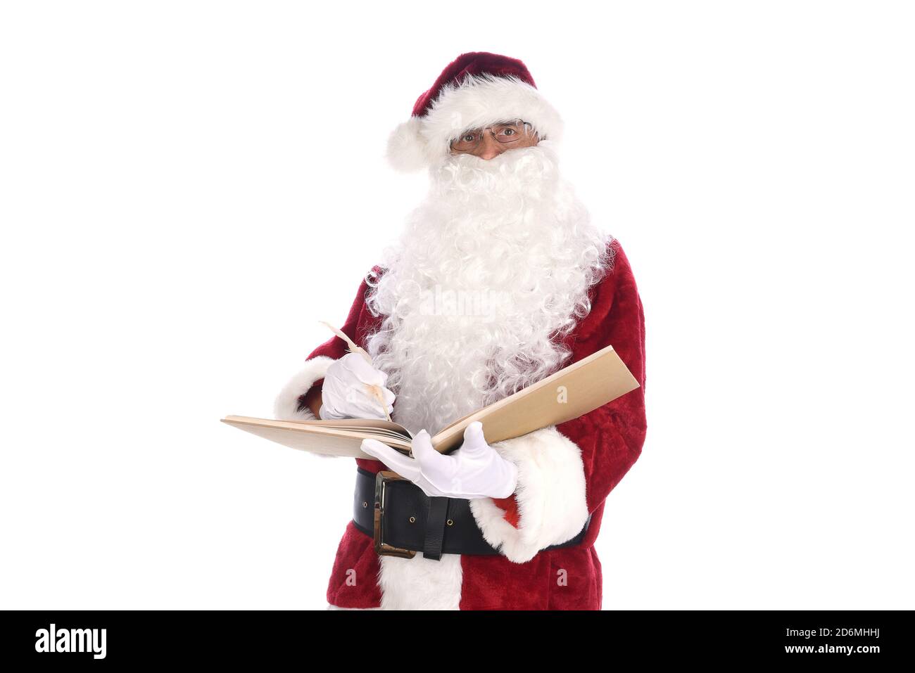 Senior man wearing a traditional Santa Claus costume writing with a ...