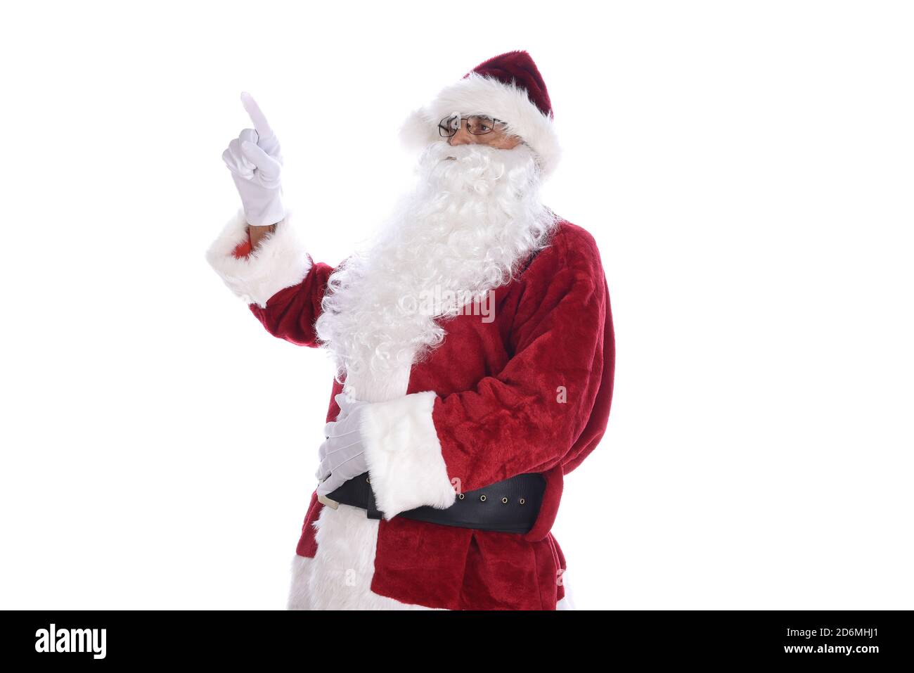 Side view of a senior man in traditional Santa Claus costume pointing ...