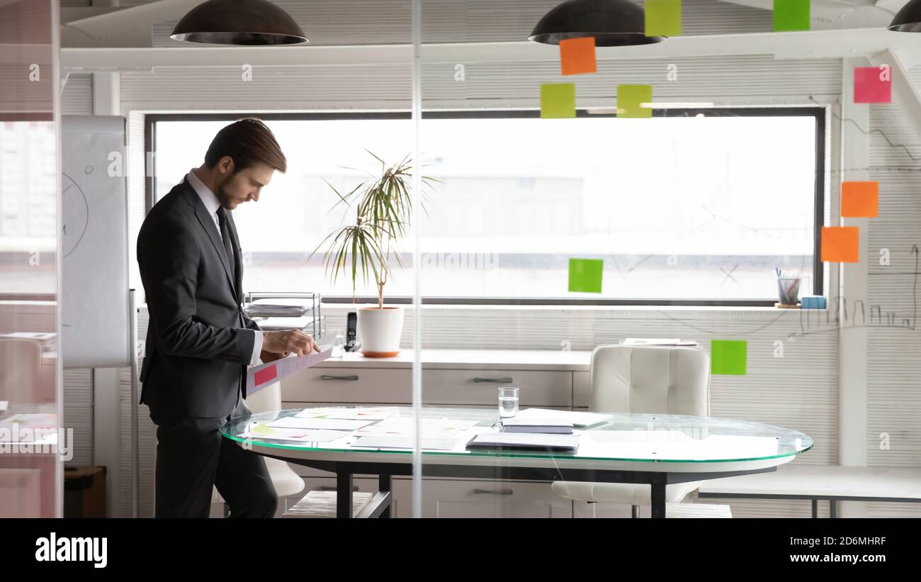 Focused busy male manager reading document in office Stock Photo - Alamy