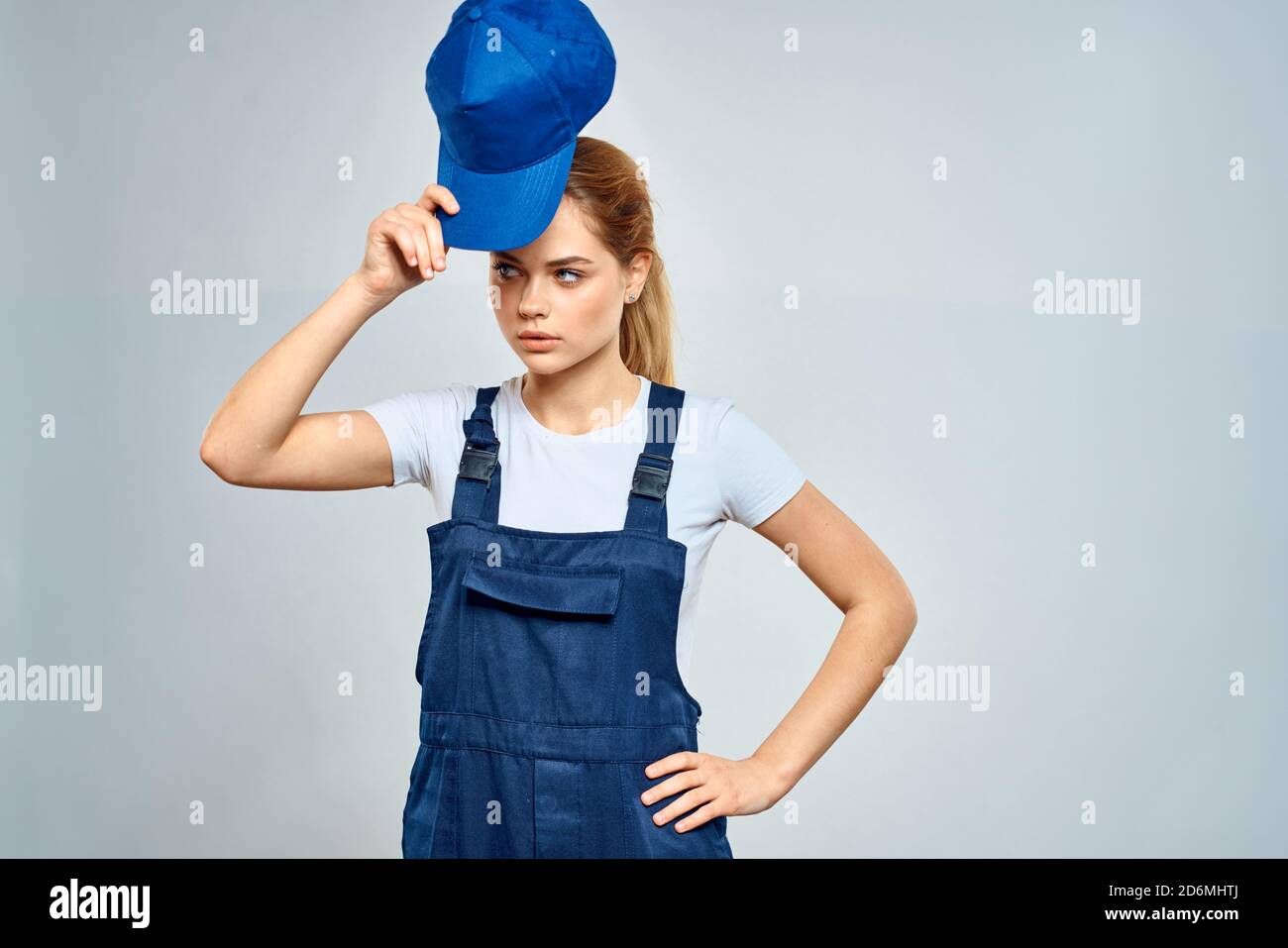 woman in work uniform blue cap service delivery service light ...