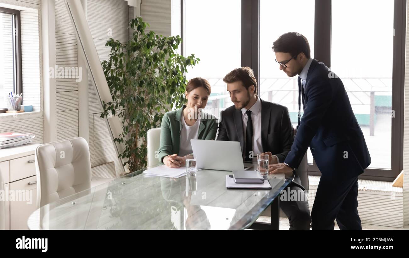 Focused young business people looking at computer screen Stock Photo ...