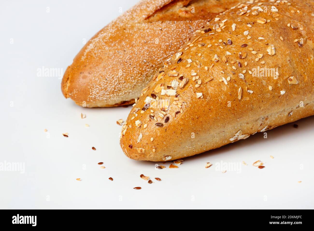 Two loaves of bread of different kind close up isolated on white ...