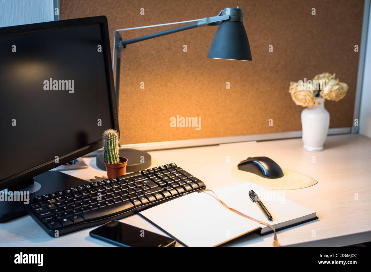 Workplace with PC, notebook and lamp, working late Stock Photo - Alamy