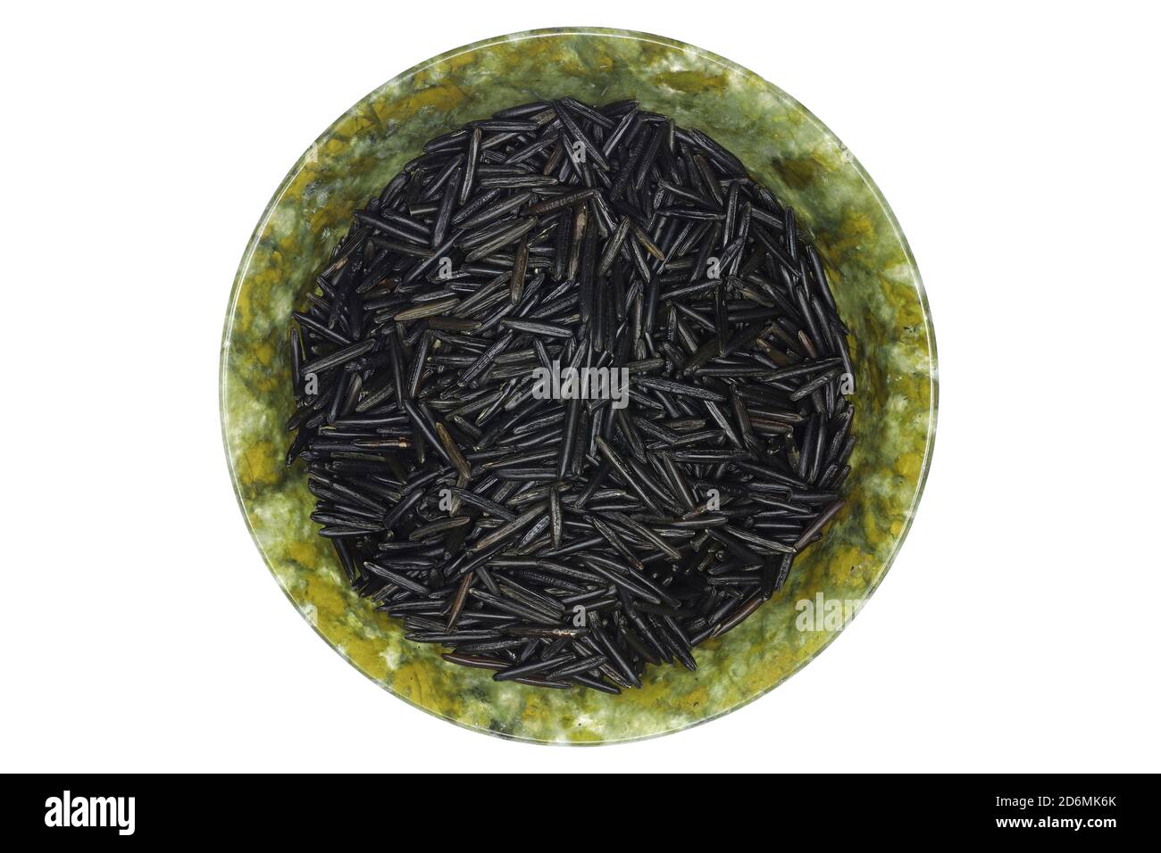 wild rice in a vintage spinach jade bowl isolated on white background ...