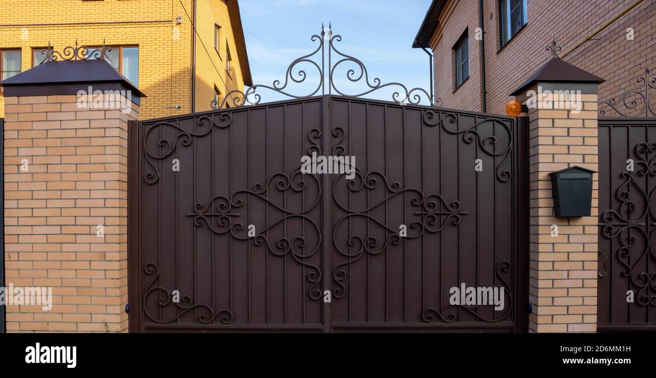 New forged metal double gates for entry of cars into the yard closed ...