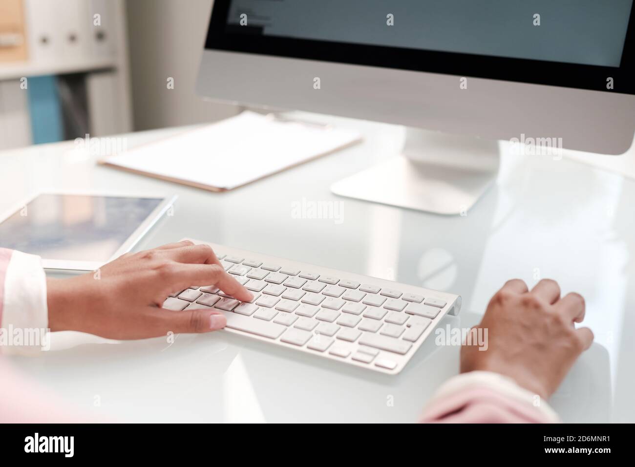 Hands of young contemporary businesswoman keeping fingers on keypad ...
