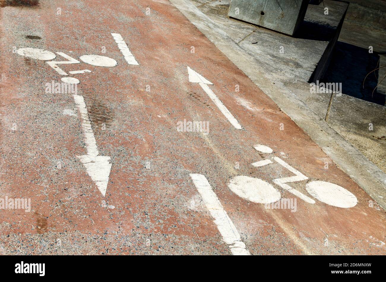 Bike path. White signs painted on the floor indicating directions Stock ...