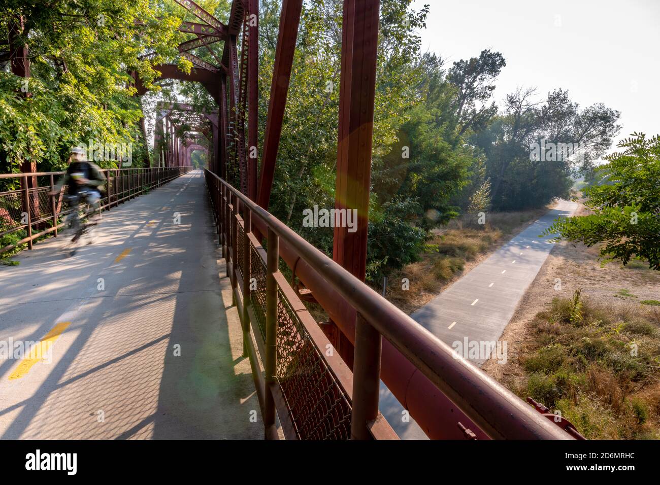 Beautiful city park bridge with a bike rider Stock Photo - Alamy