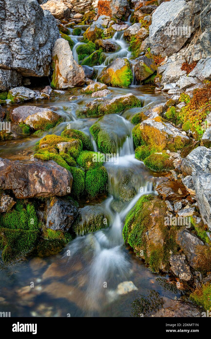 Rocky waterfall as water flows down from the mountains Stock Photo - Alamy
