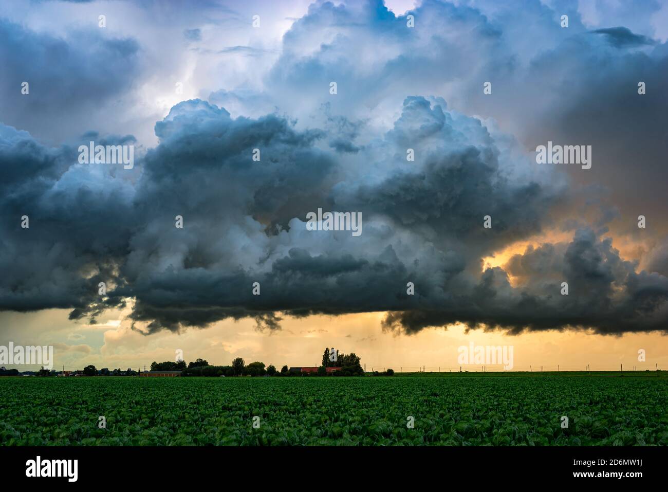 Dramatic looking storm clouds over farmland at sunset Stock Photo - Alamy