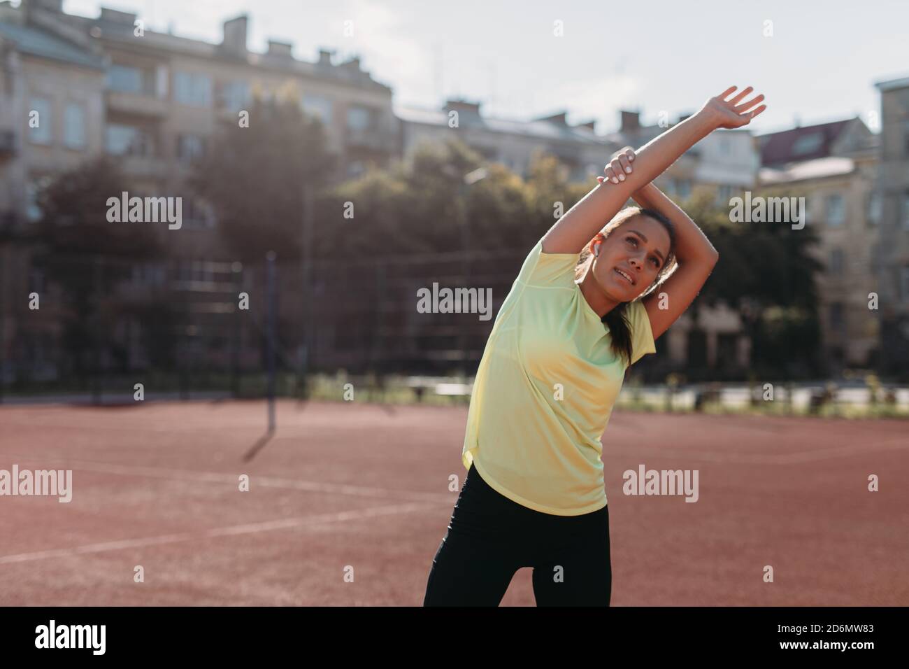 Beautiful female warming up before morning training Stock Photo - Alamy
