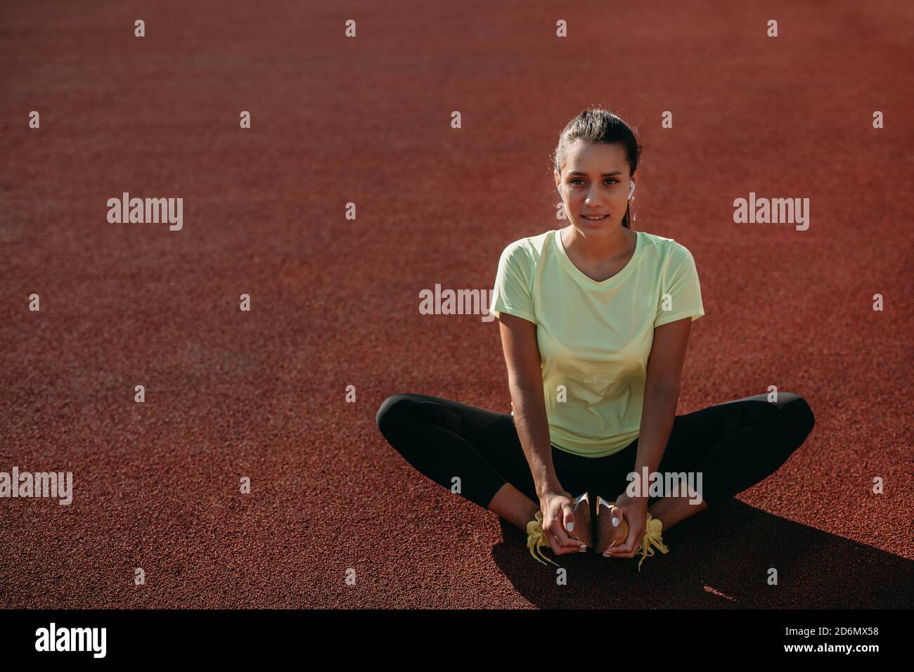 Strong dark-haired woman doing exercises for legs Stock Photo - Alamy
