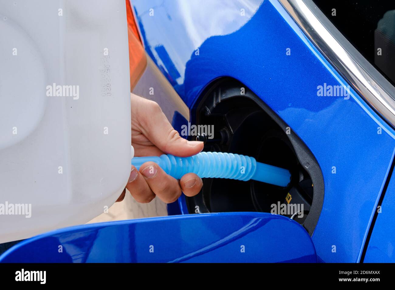 Close up filling of diesel exhaust fluid from canister into the tank of ...