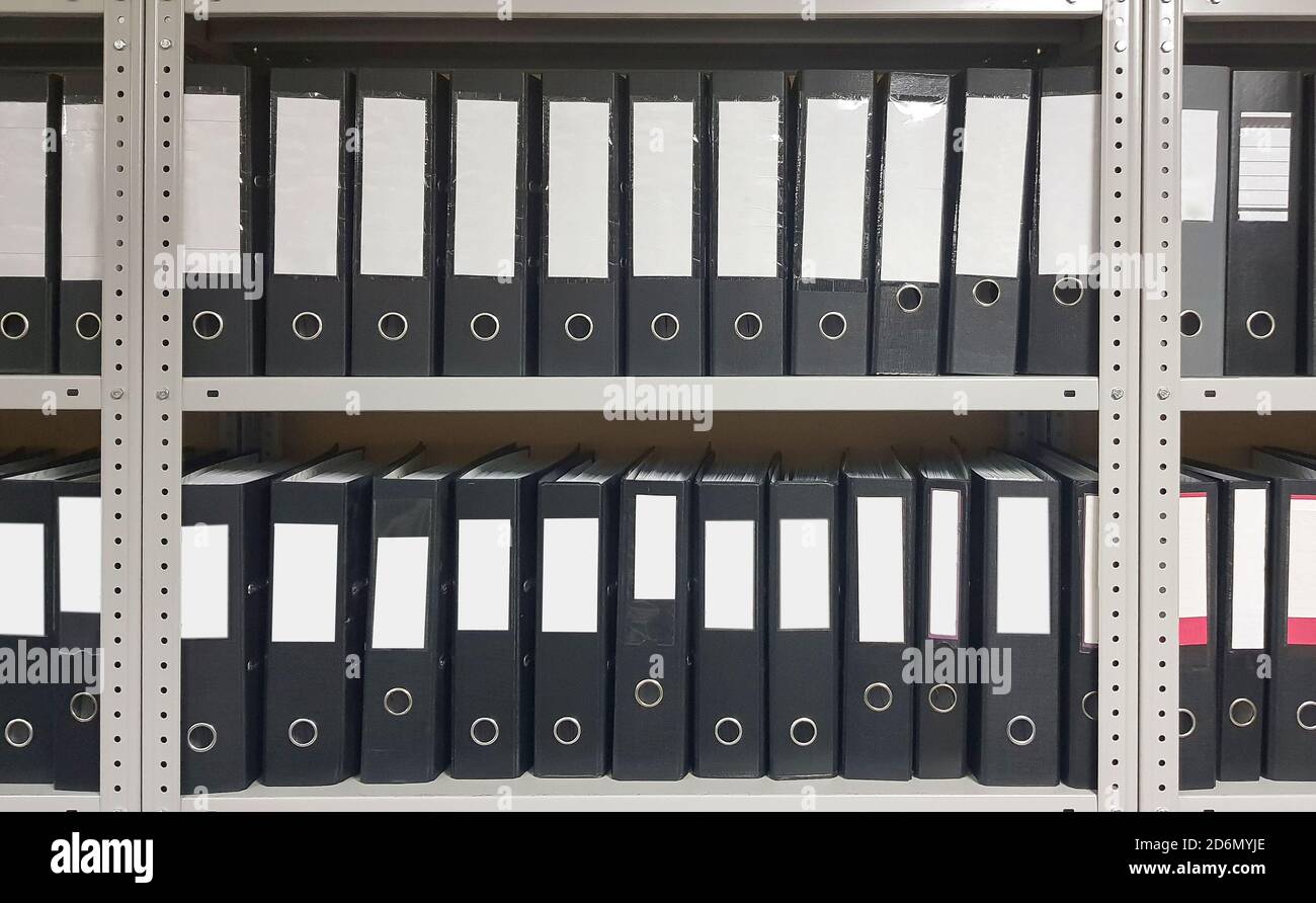 Office shelf with a lot of folders. Papers, documents and catalogs ...