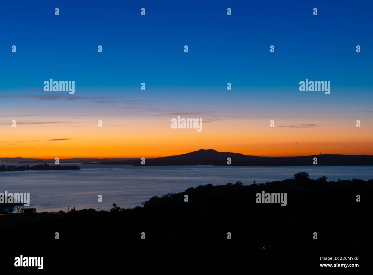 Sunset across Waitemata Harbour in Auckland bright blue and red sky ...