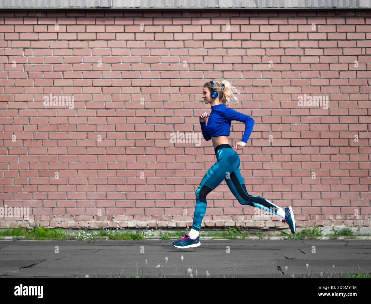 Woman jogging outdoor in a sunny day. Sport and healthy lifestyle ...