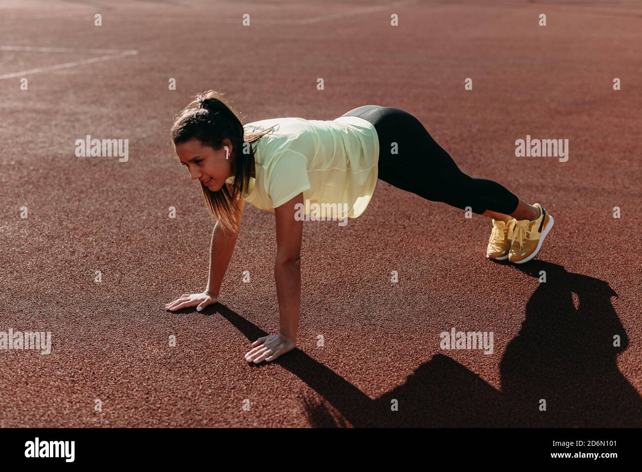 Woman in sportswear performing plank on straight hands Stock Photo - Alamy