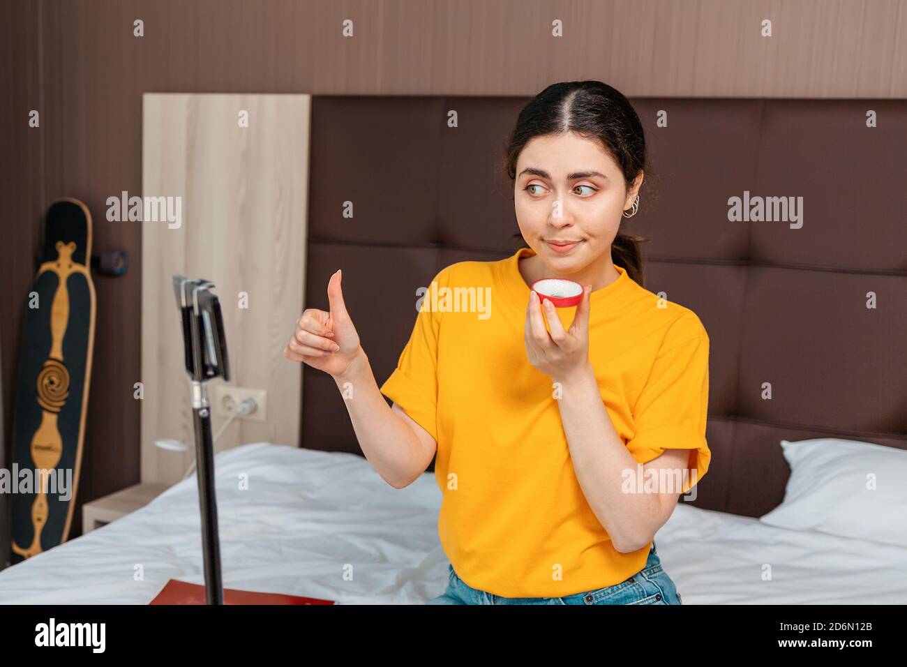 Portrait of pretty female vlogger streaming a live video to her ...