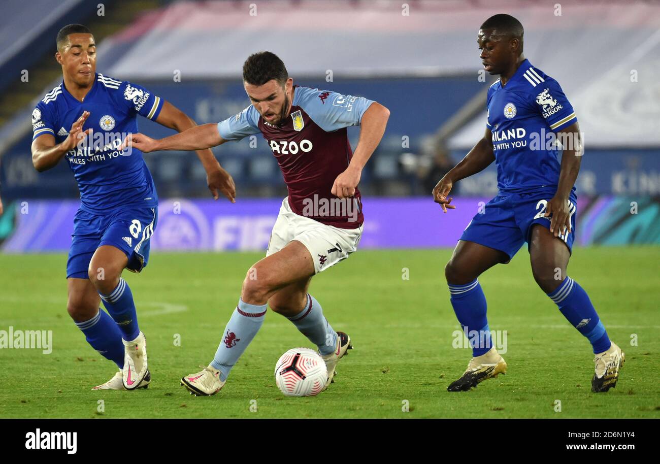 Aston Villa's John McGinn (centre) battles for the ball with Leicester City's Youri Tielemans ...
