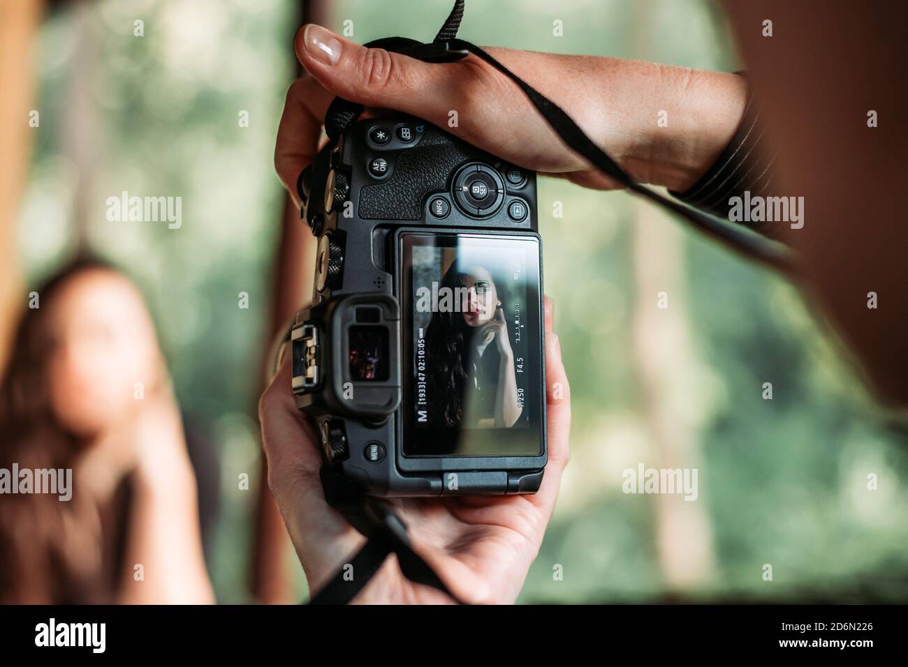 Female photographer takes portrait photos of a girl. Close up on camera ...