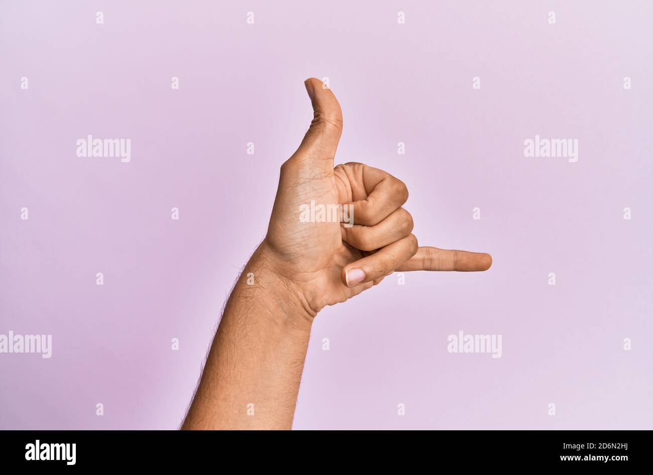 Arm and hand of caucasian young man over pink isolated background ...