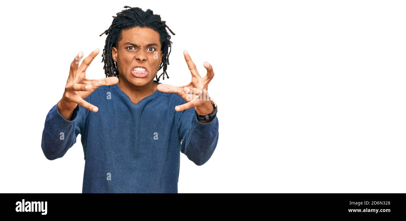 Young african american man wearing casual winter sweater shouting ...