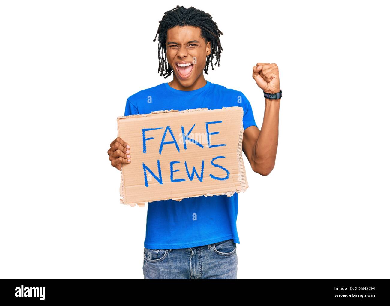 Young african american man holding fake news banner screaming proud ...