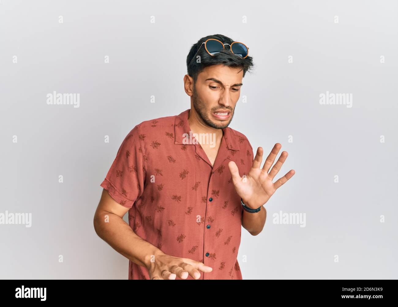 Young handsome man wearing casual summer clothes disgusted expression ...