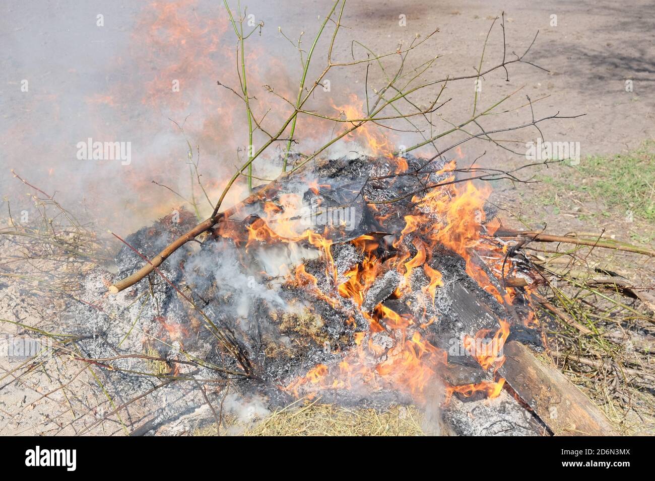 Big bonfire in the open air. A pile of ash from burnt boards and ...