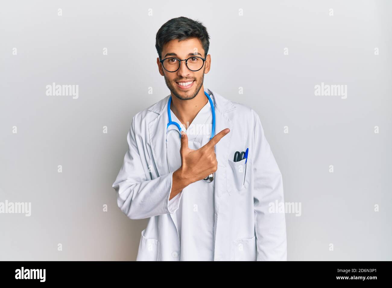 Young handsome man wearing doctor uniform and stethoscope cheerful with ...