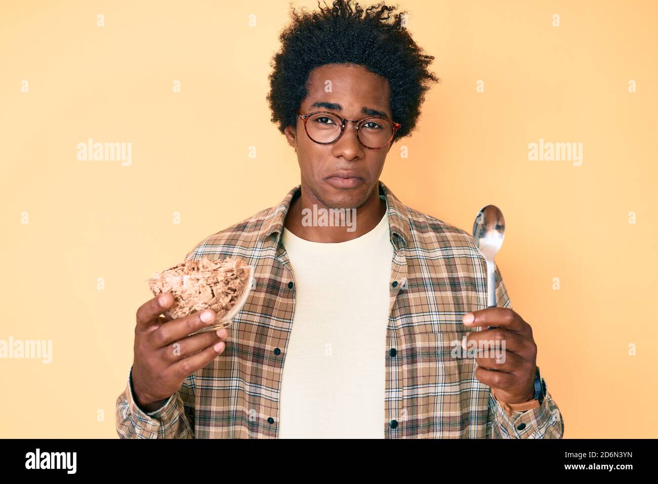 Handsome african american man with afro hair eating healthy whole grain ...
