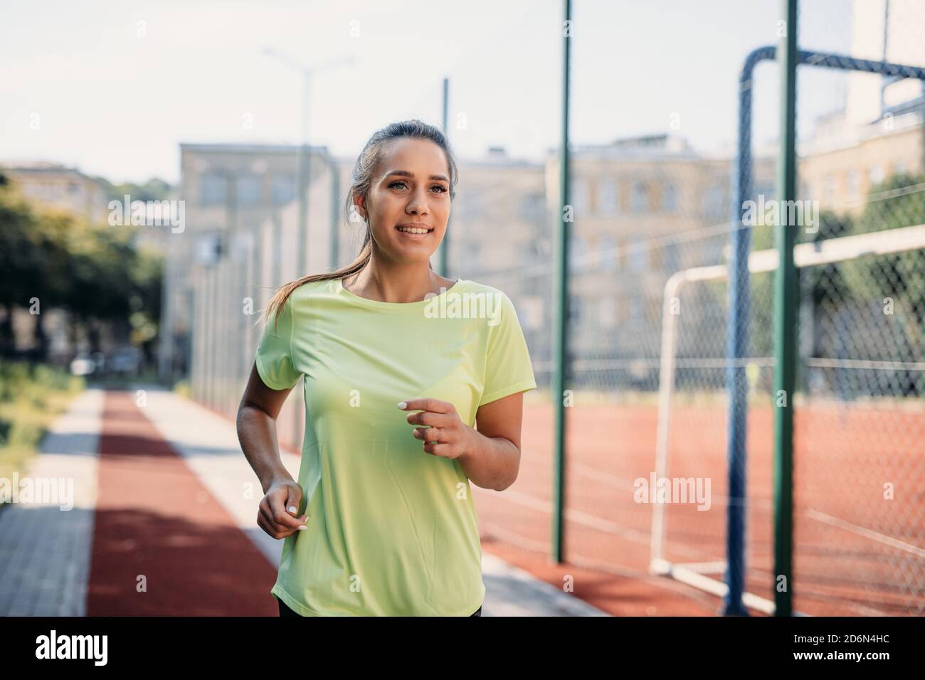 Healthy and active woman enjoying morning run at stadium Stock Photo ...
