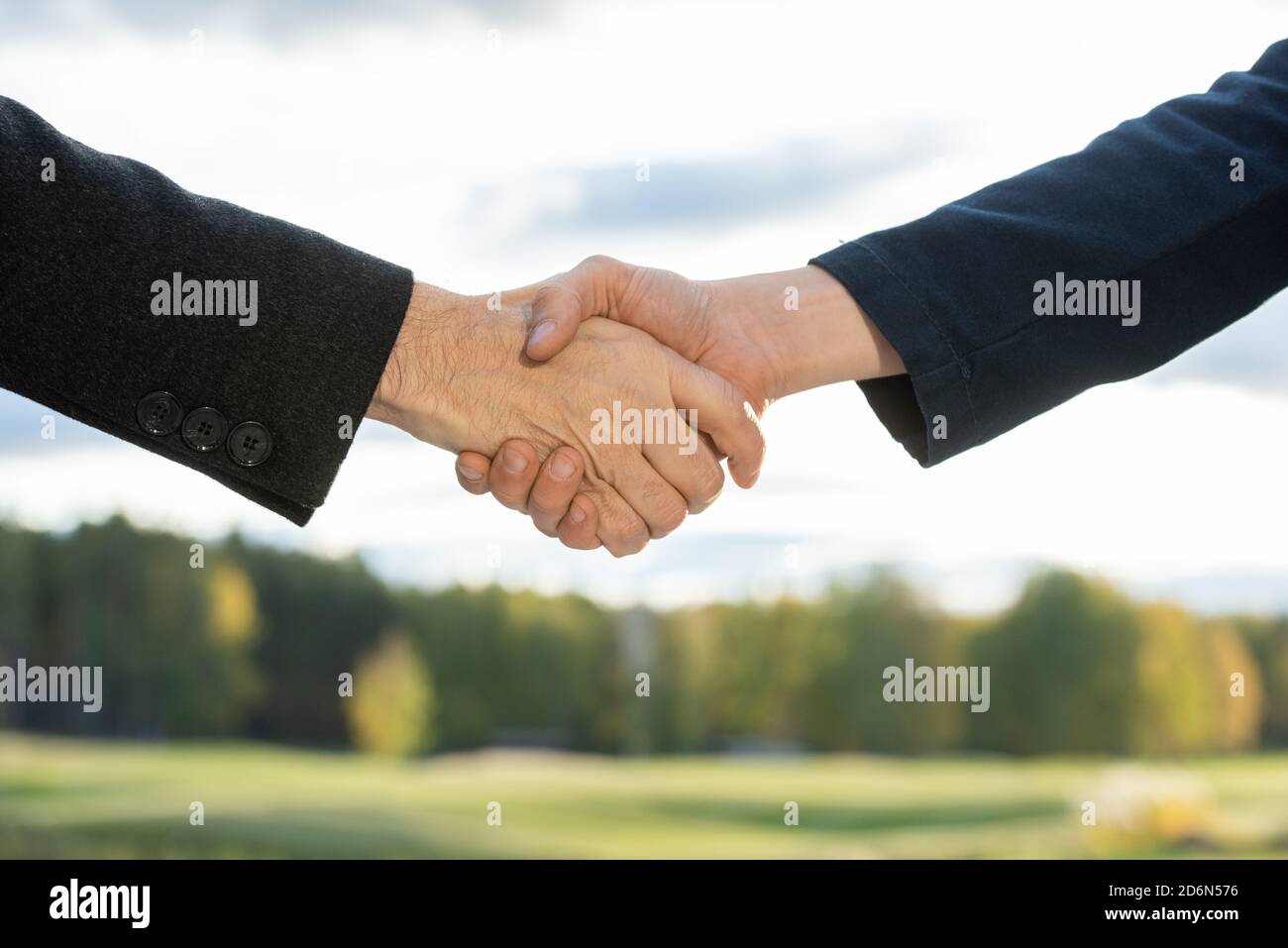 Handshake of two contemporary successful business partners against ...