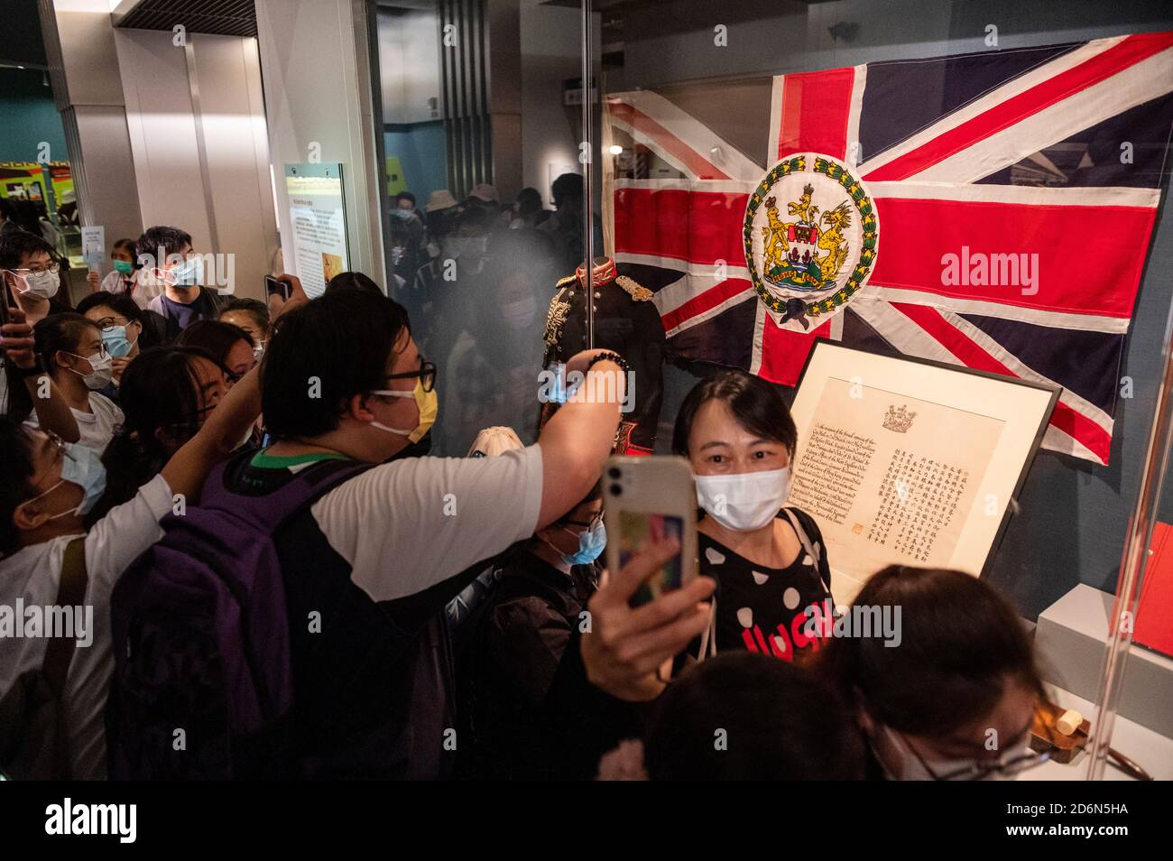Visitors take photographs of a colonial British Hong Kong flag at the ...