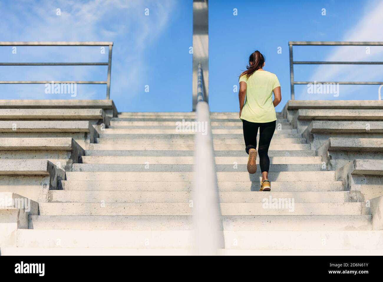 Young female athlete doing run up at local stadium Stock Photo - Alamy