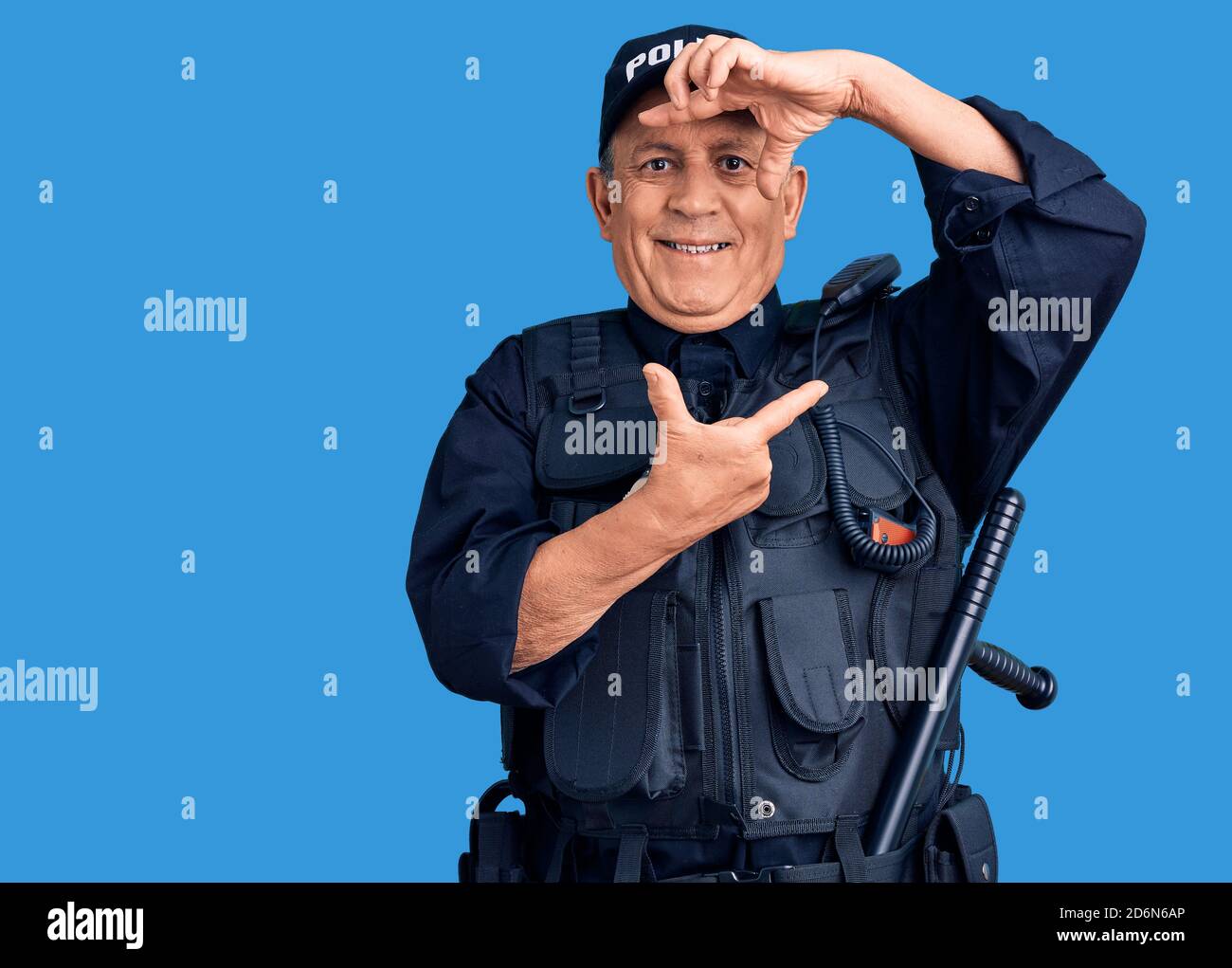 Senior handsome man wearing police uniform smiling making frame with ...