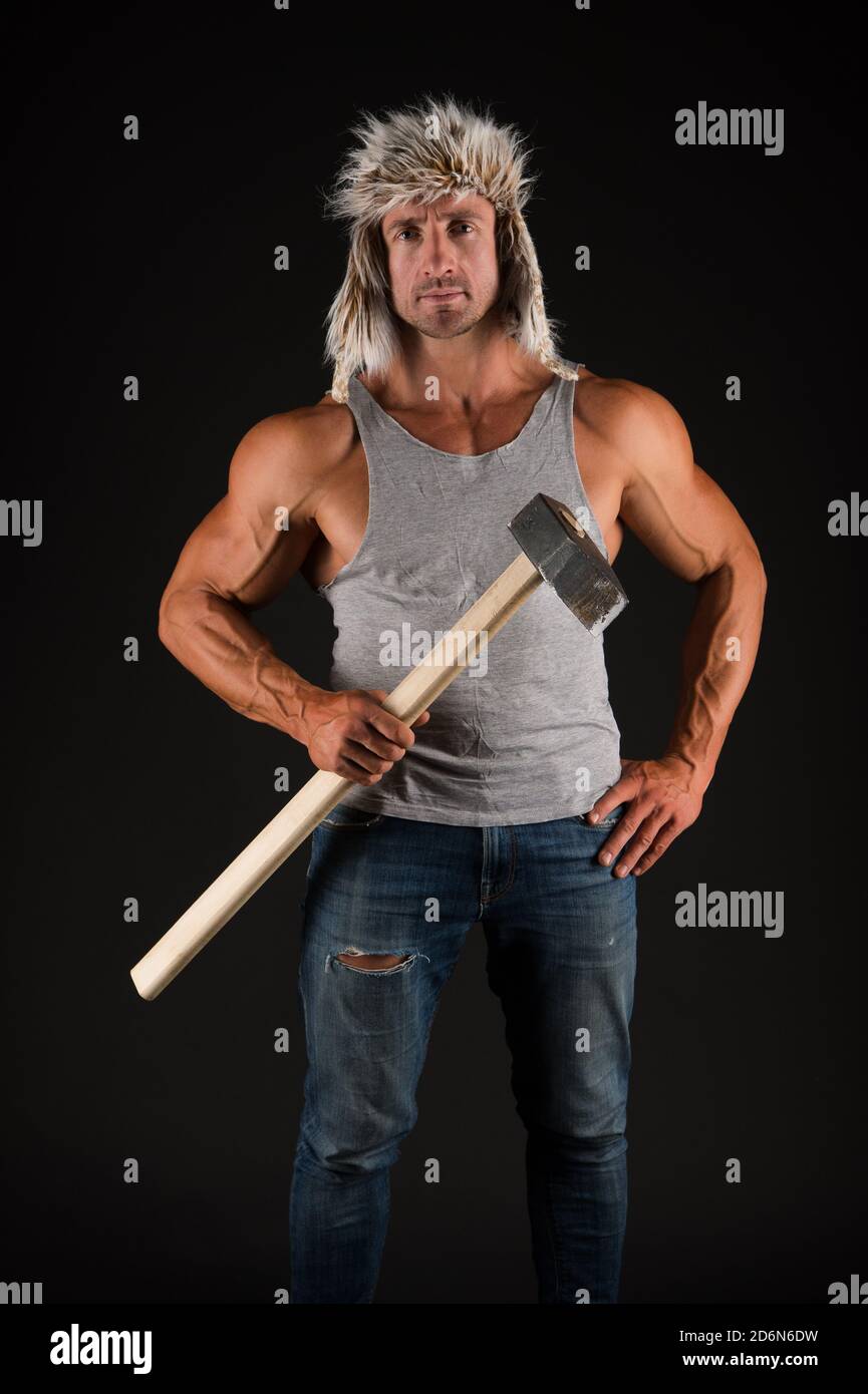Athletic worker hold hammer tool in strong arms biceps triceps in ...