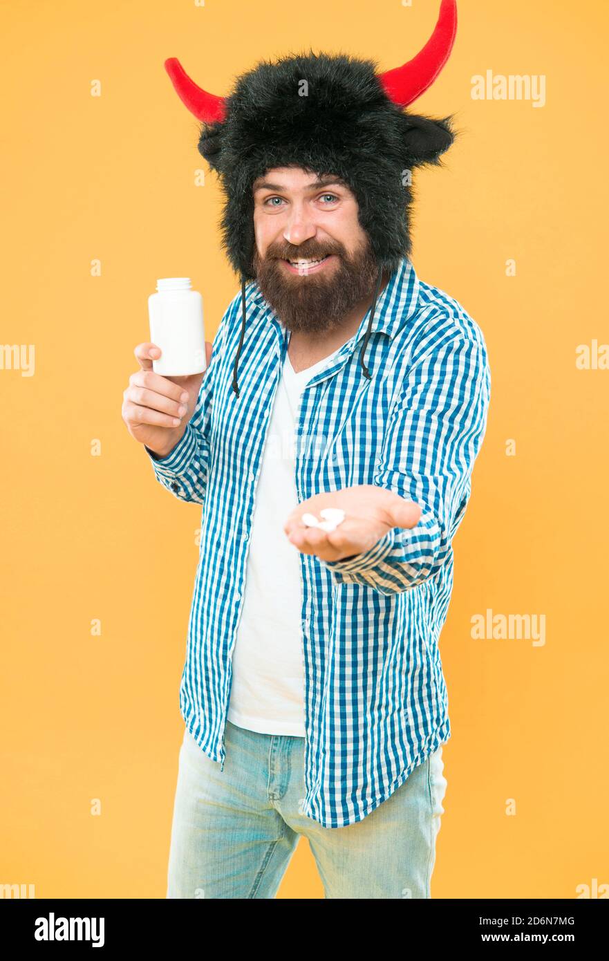 Giving drugs. Sick man take drugs. Bearded man hold drug package. Oral ...