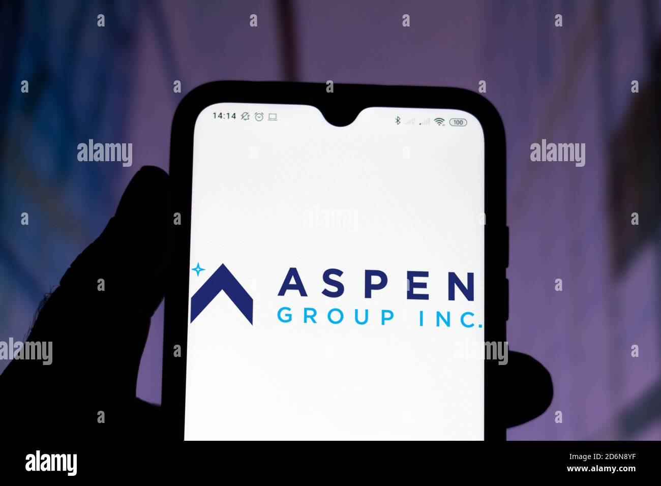 In this photo illustration the Aspen Group logo seen displayed on a ...
