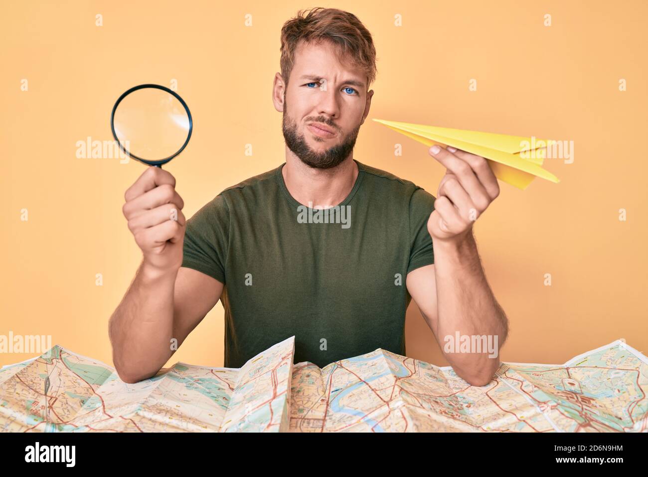 Young caucasian man searching at the map for destination holding paper ...