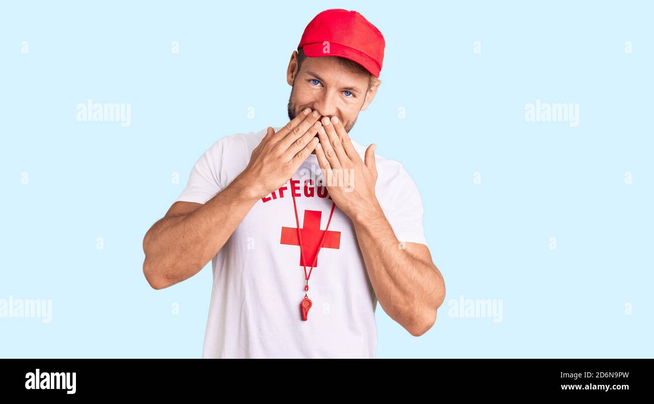 Young caucasian man wearing lifeguard t shirt holding whistle laughing ...