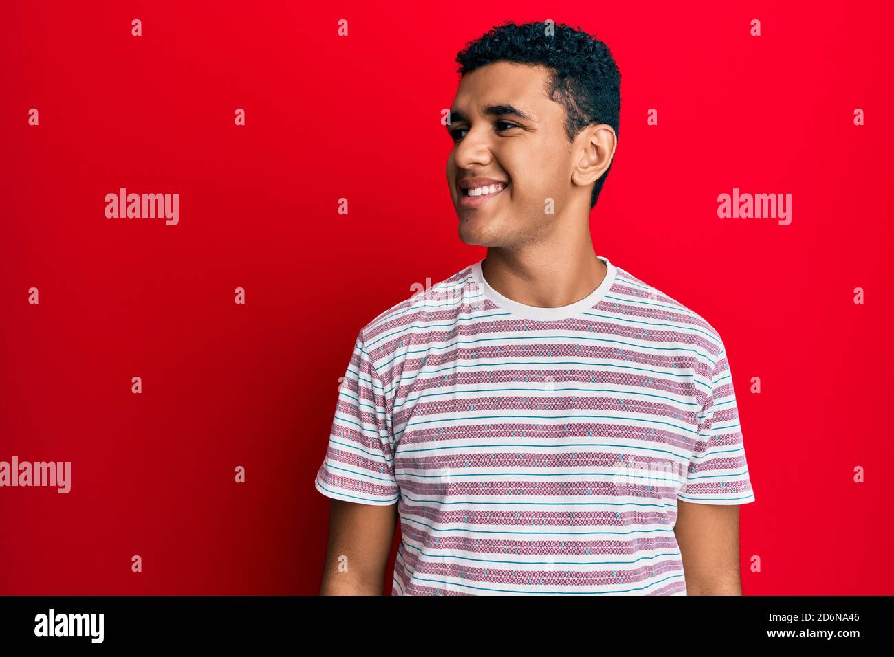 Young arab man wearing casual clothes looking to side, relax profile ...