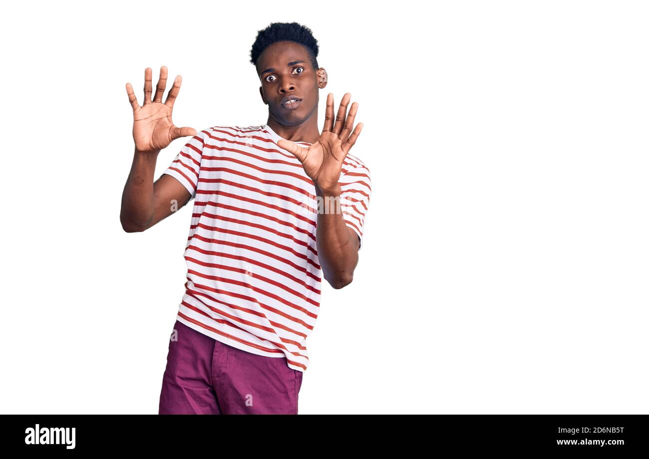 Young african american man wearing casual clothes afraid and terrified ...
