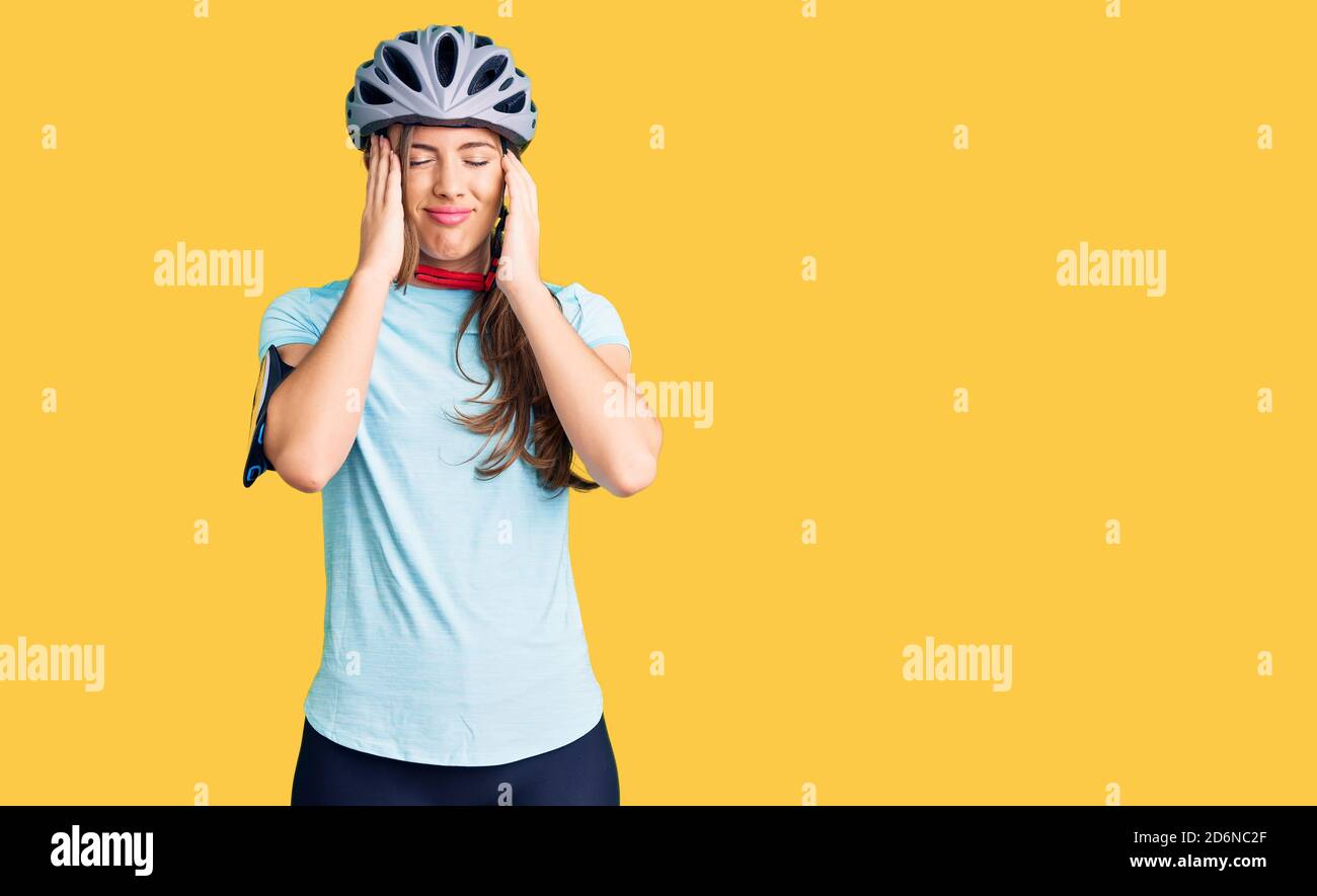 Beautiful caucasian young woman wearing bike helmet suffering from ...