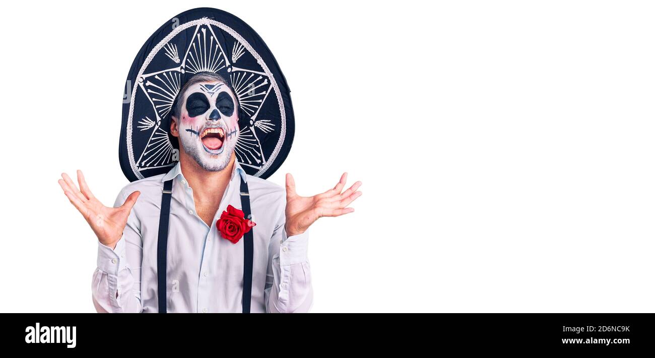 Man wearing day of the dead costume over background crazy and mad ...