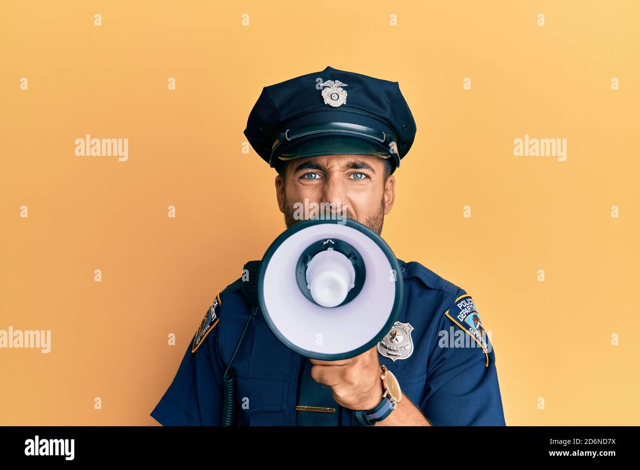 American police officer shouting through megaphone, yelling and ...