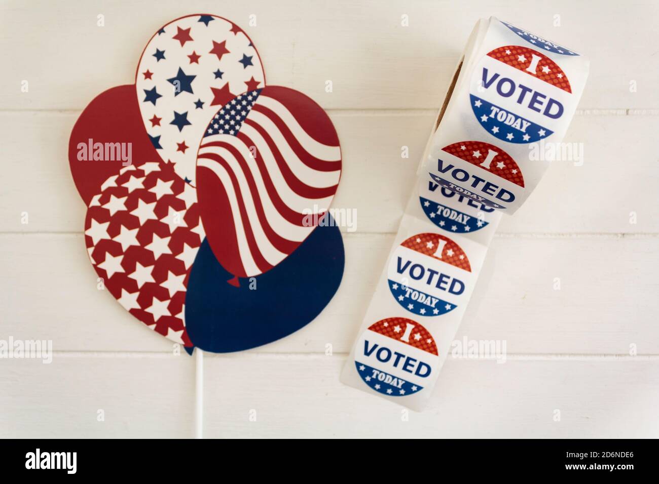 I Voted Today stickers and USA balloons on white wooden table. US ...