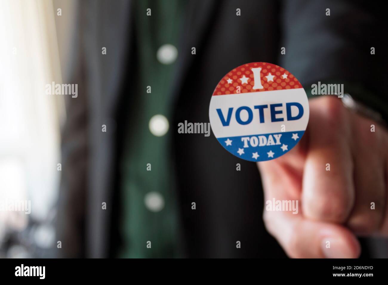 Patriotic man with I Voted today sticker on his finger Stock Photo - Alamy